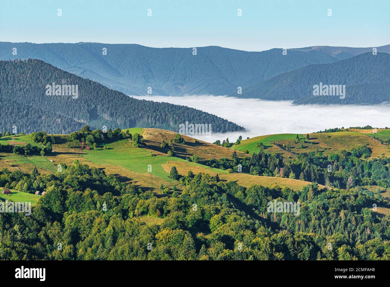 View of the mountain landscape and the mist-shrouded valley Stock Photo ...