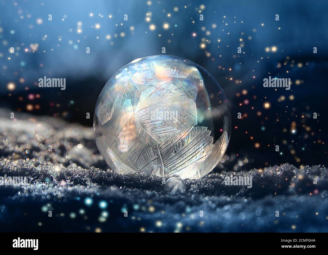 Magical color glitter frostball on cold winter snow, crystal formations ...