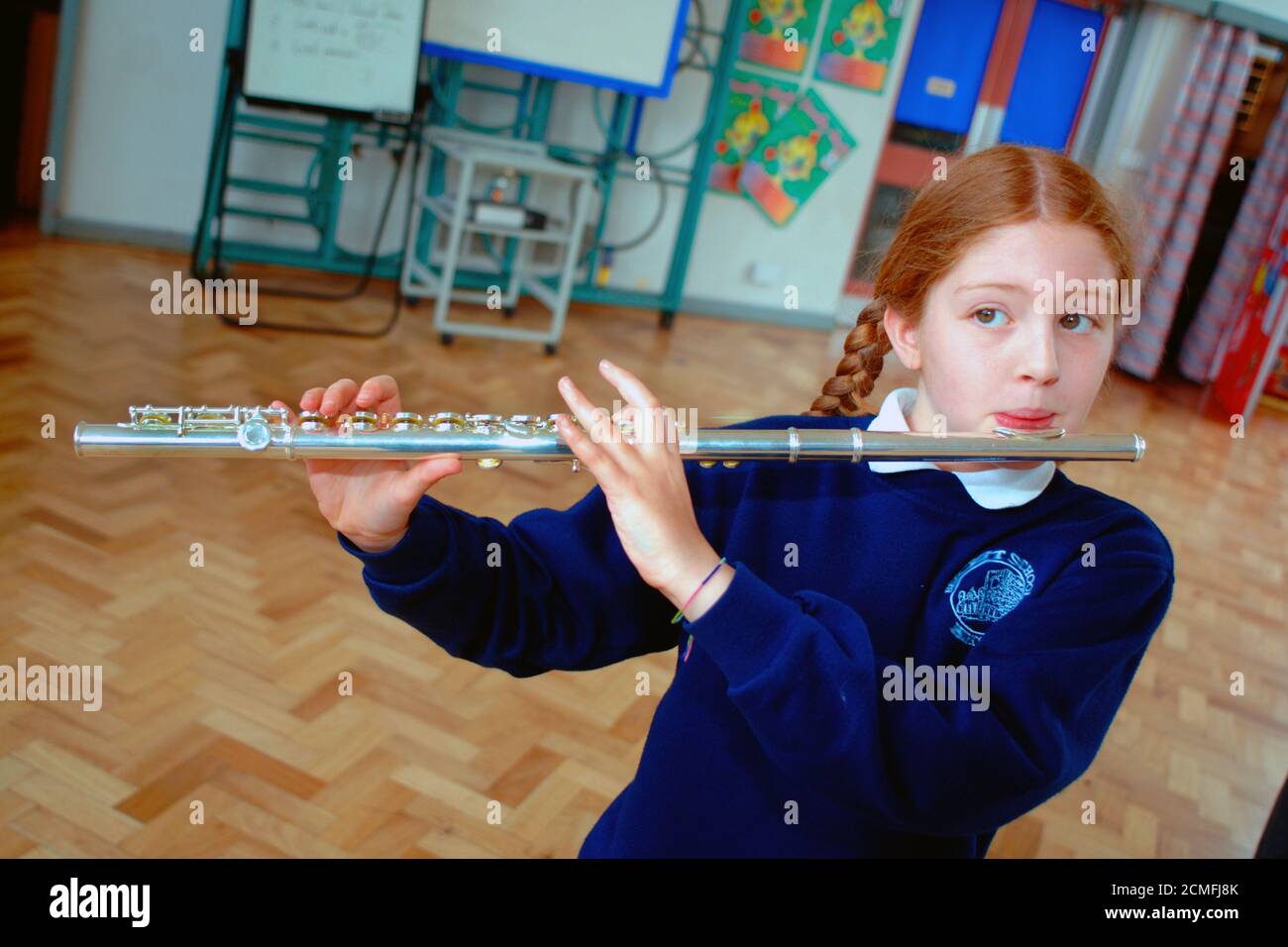 Primary schoolgirl playing flute at school UK Stock Photo - Alamy