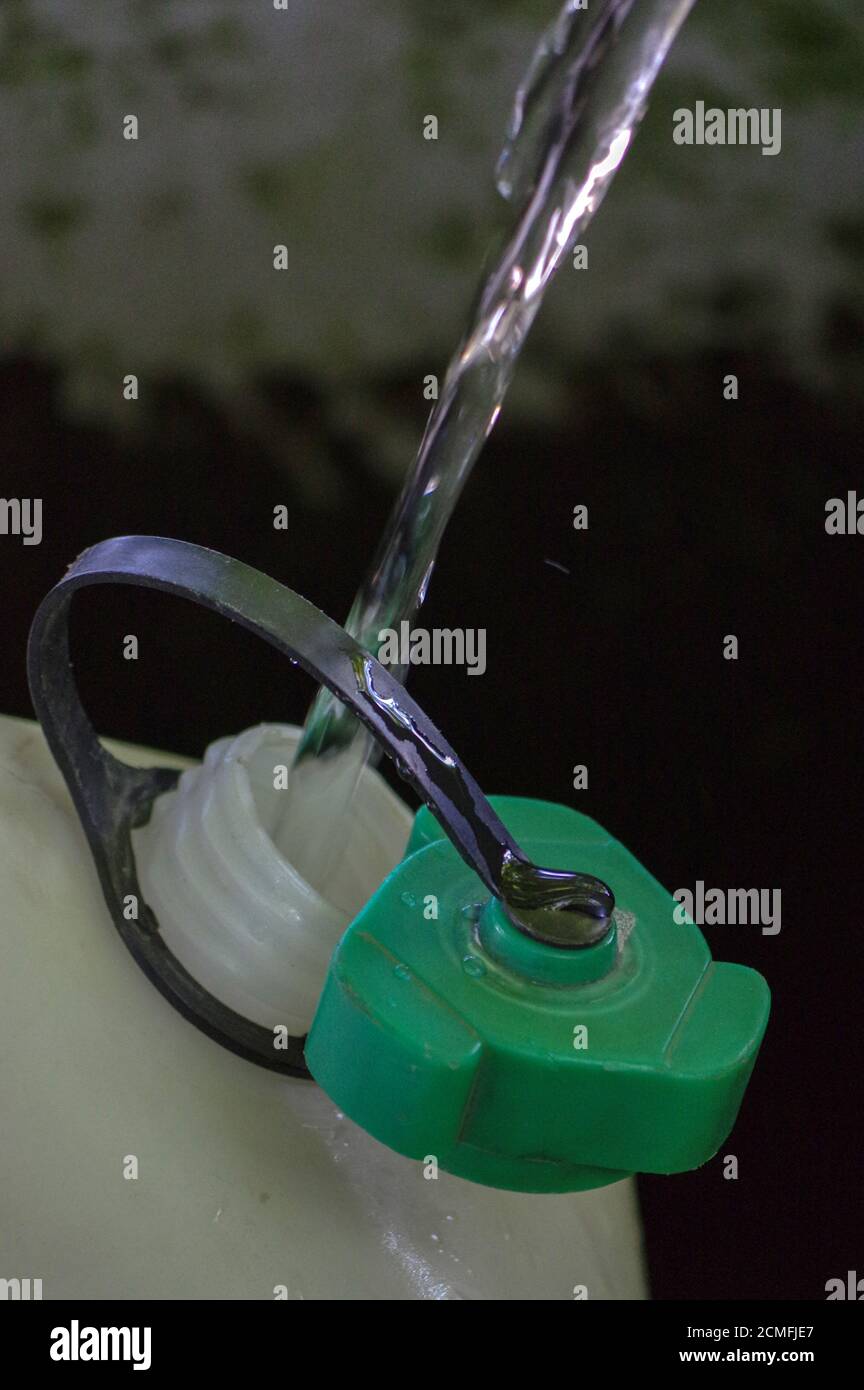 plastic tank ist filling up from tap with fresh running water at source ...