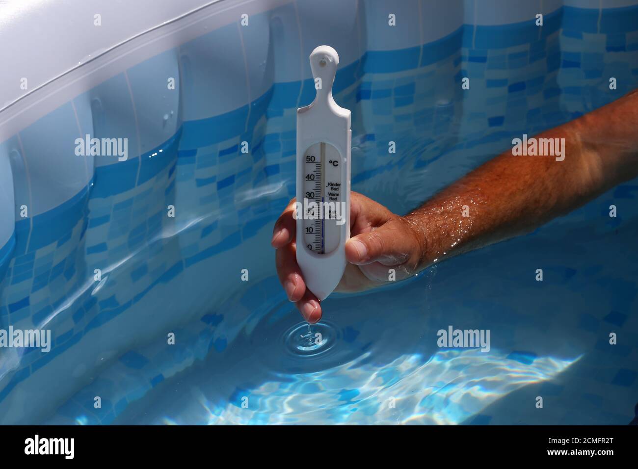 Thermometer checking the temperature of the pool water Stock Photo - Alamy