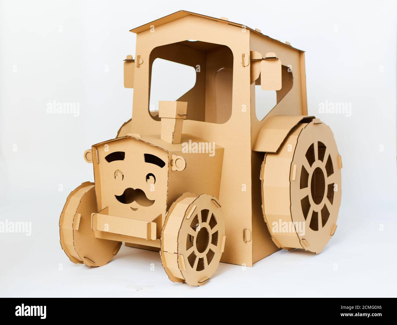 Cardboard tractor on a white background. Agriculture concept. Mockup ...