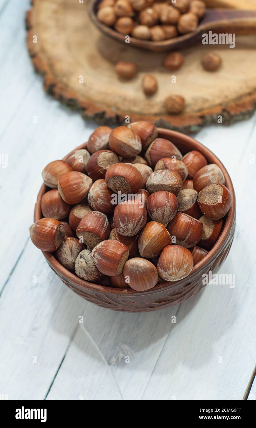 hazelnuts in the shell in brown clay bowl Stock Photo - Alamy