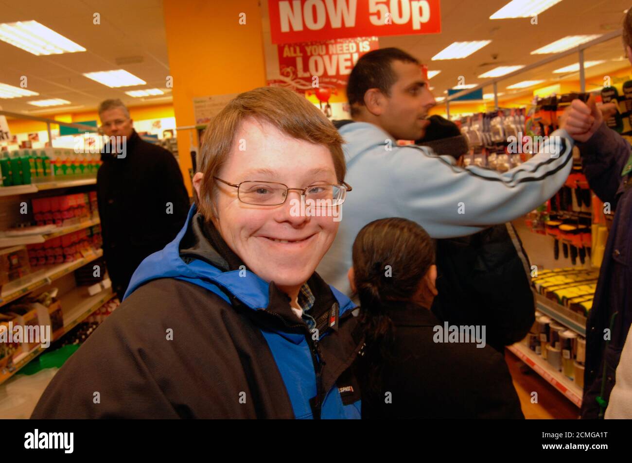 Group of men with learning disabilities shopping with carer; Bradford ...