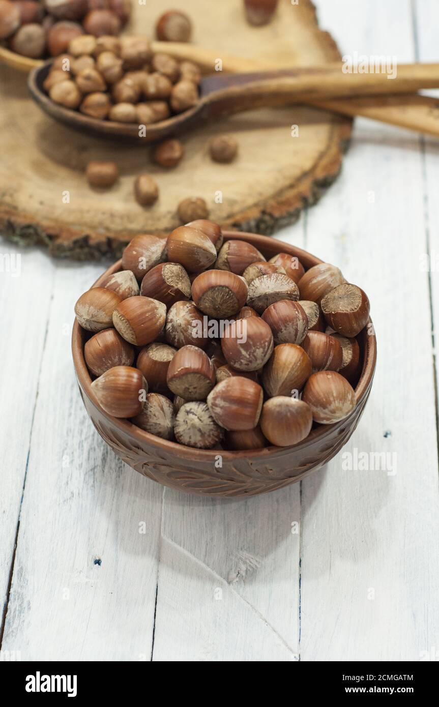 Hazelnut in the shell on a clay plate Stock Photo - Alamy