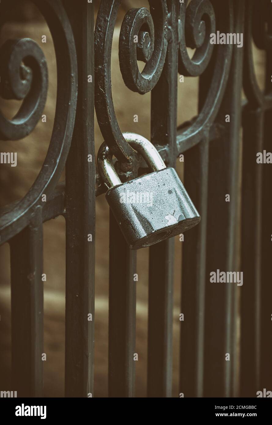 Iron lock on the black forged fence Stock Photo - Alamy