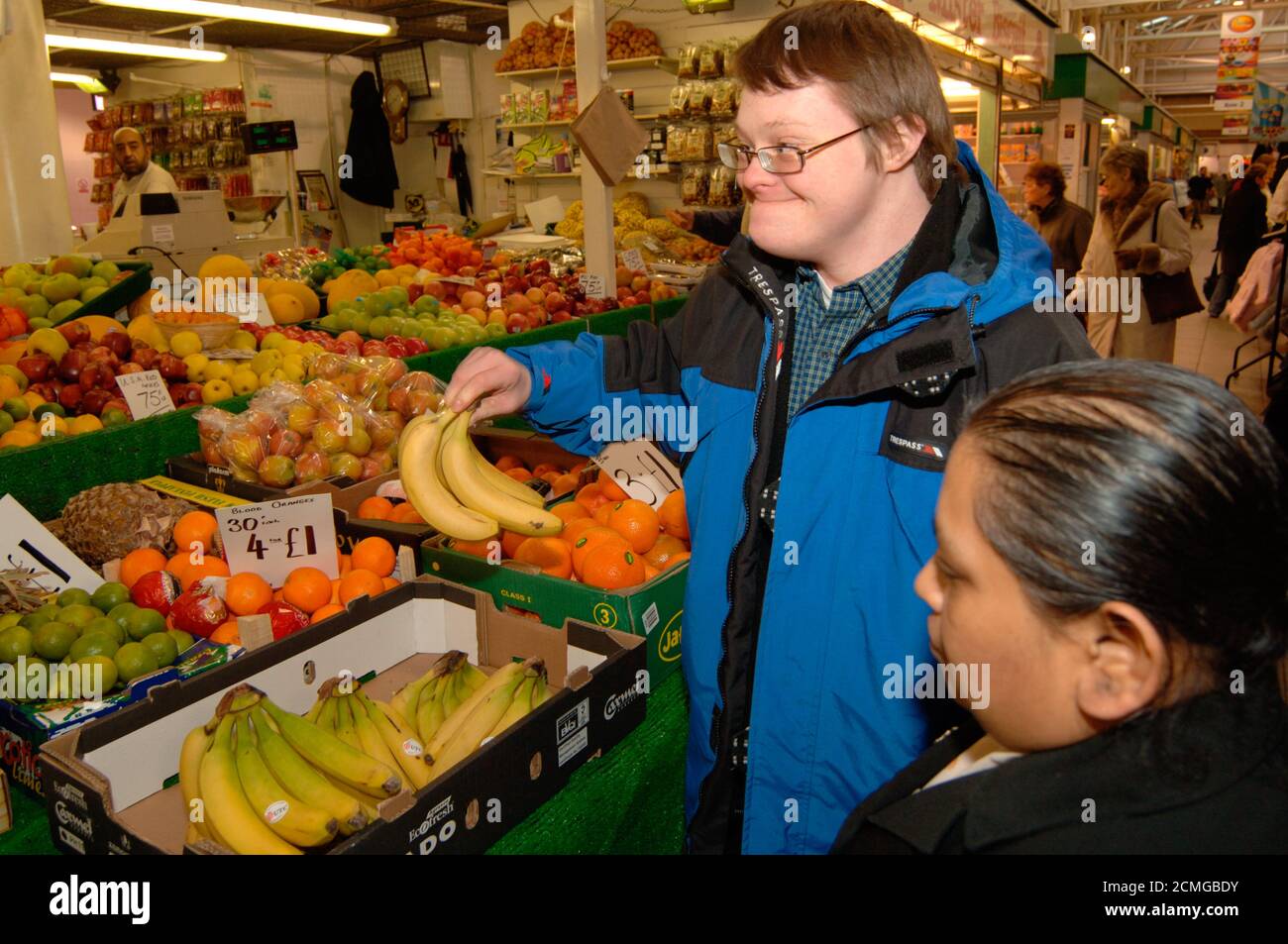 Group of men with learning disabilities shopping with carer; Bradford ...