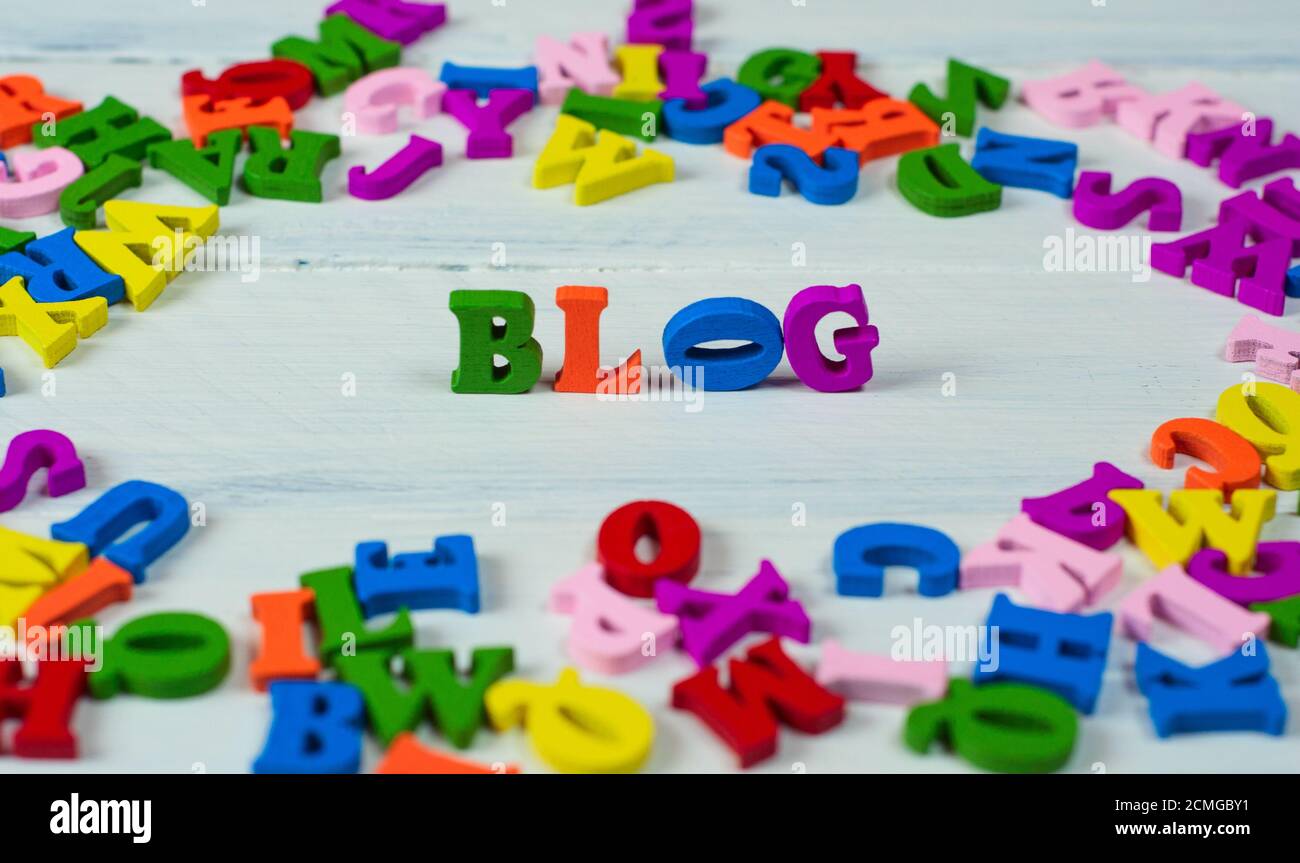 Wooden colorful letters of the English alphabet on a white wooden ...