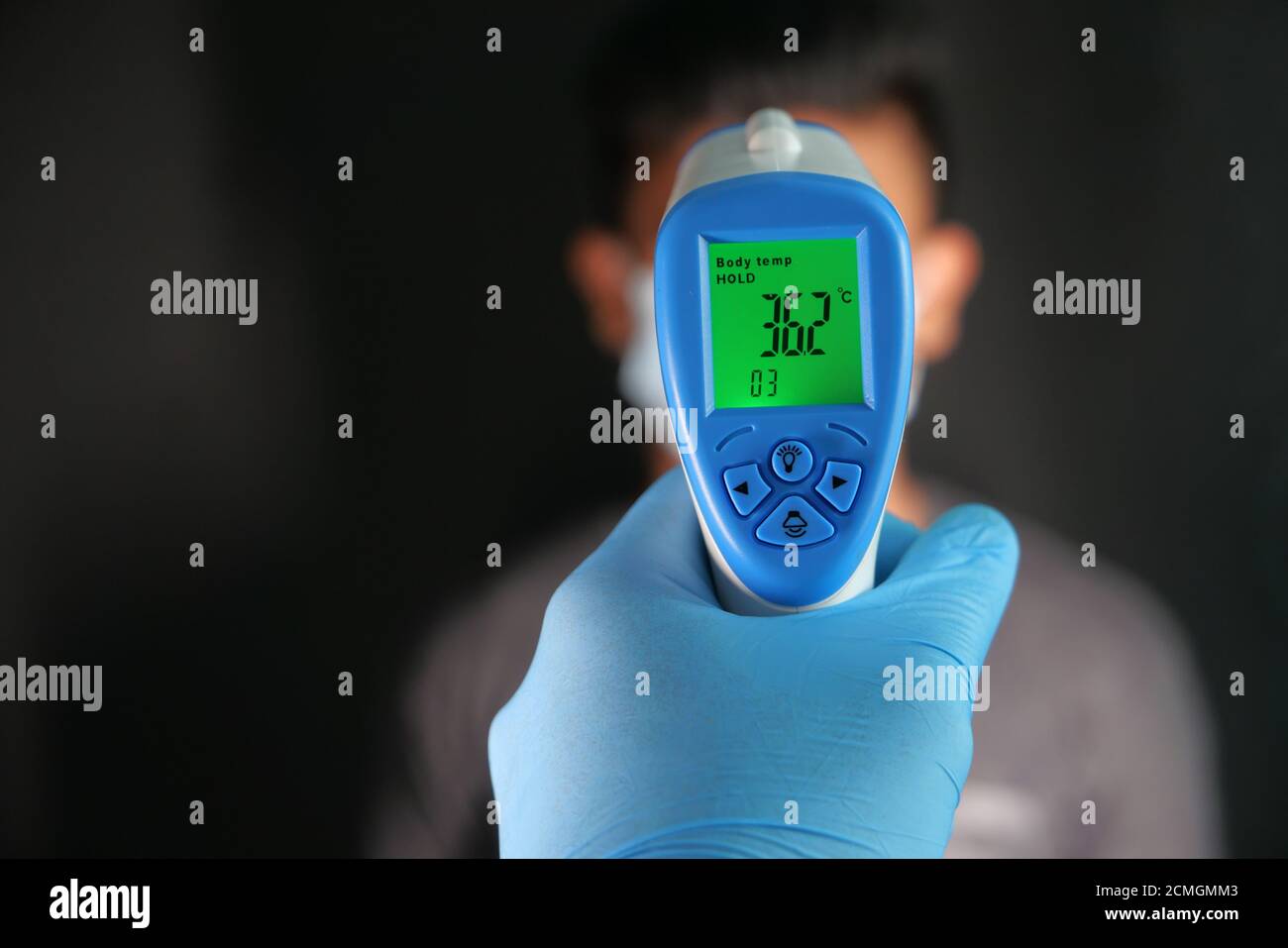 Hand holding infrared thermometer to measuring temperature Stock Photo ...