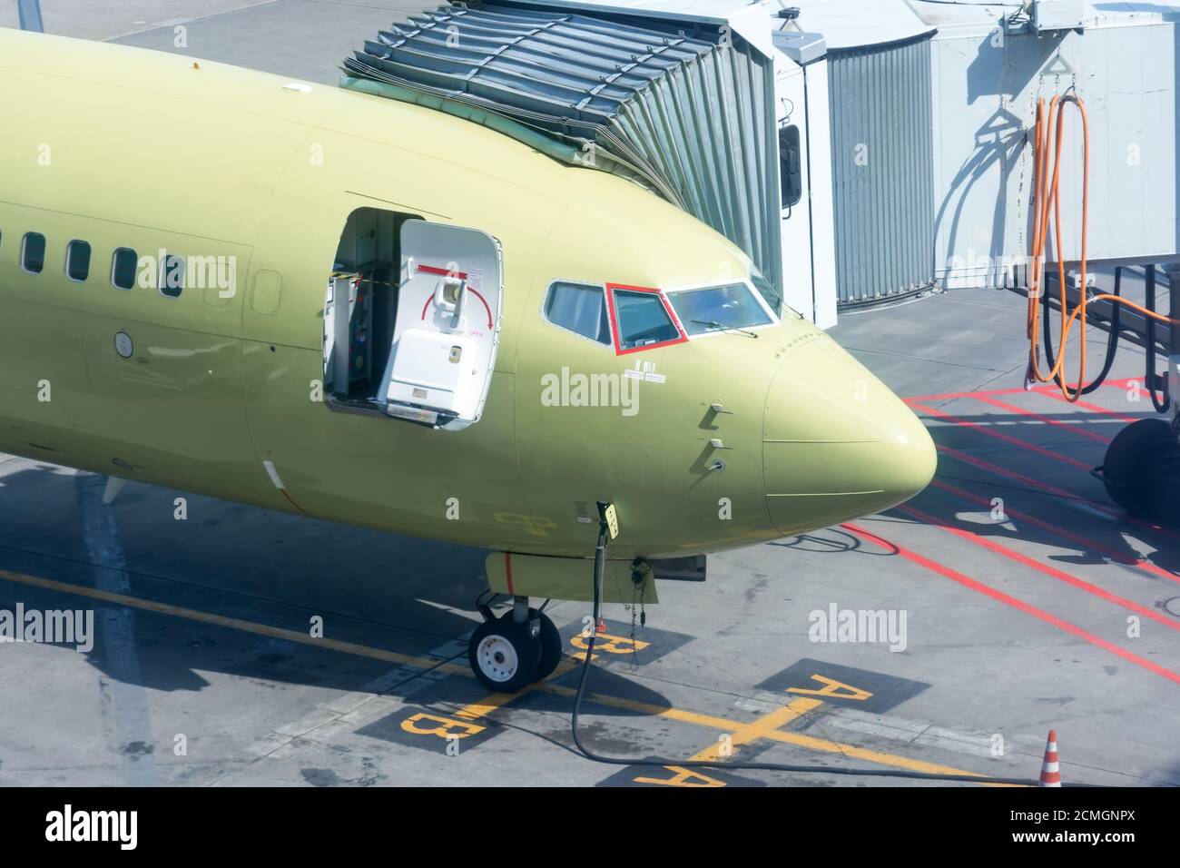 The nose and cockpit of the aircraft with the front door open at the ...