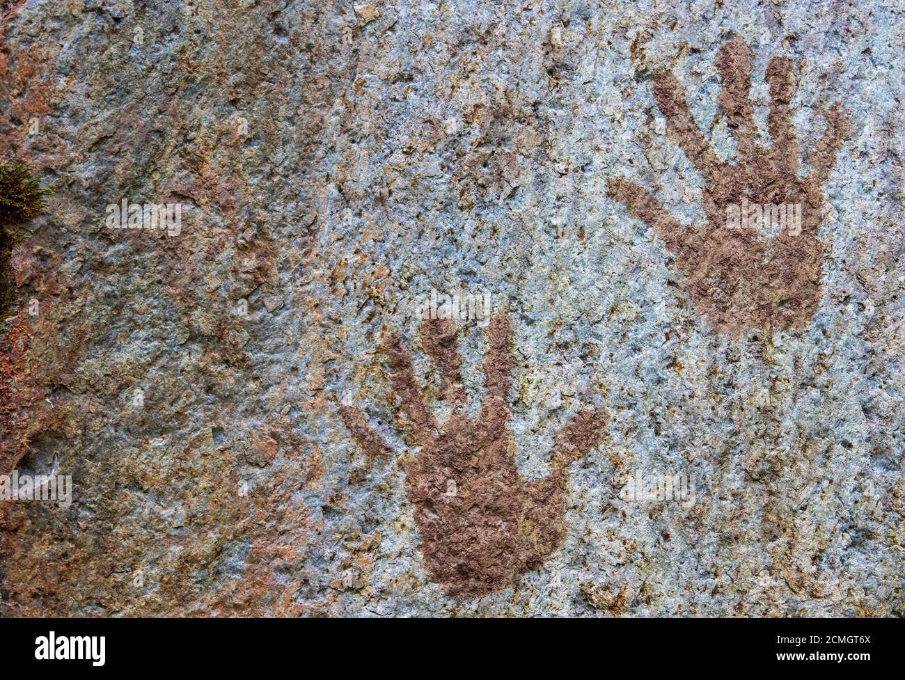 Human hand prints painted on stone surface Stock Photo - Alamy