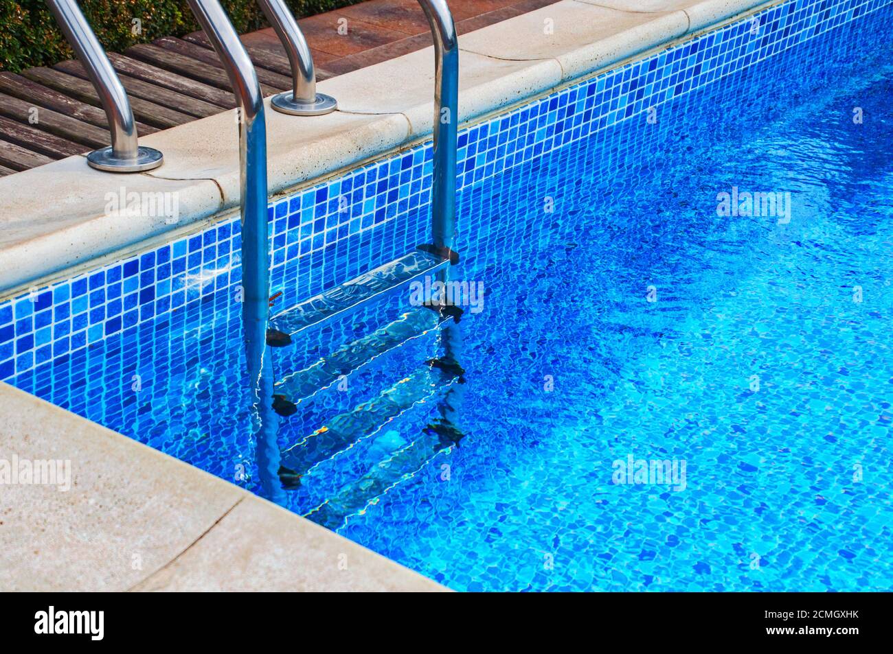 Iron staircase in the pool with blue tiles Stock Photo - Alamy