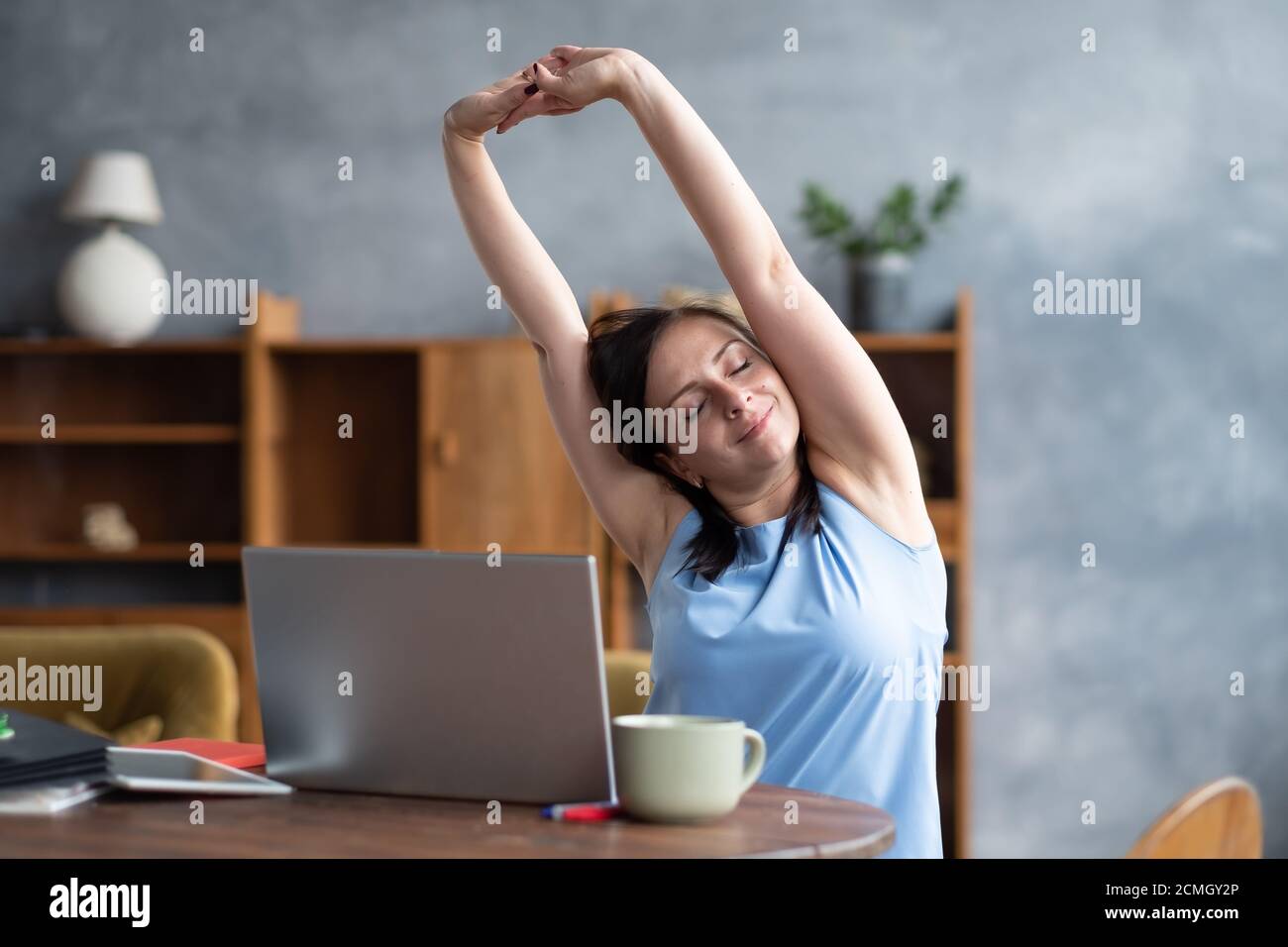 woman performing a side stretching exercise for the spine working at ...