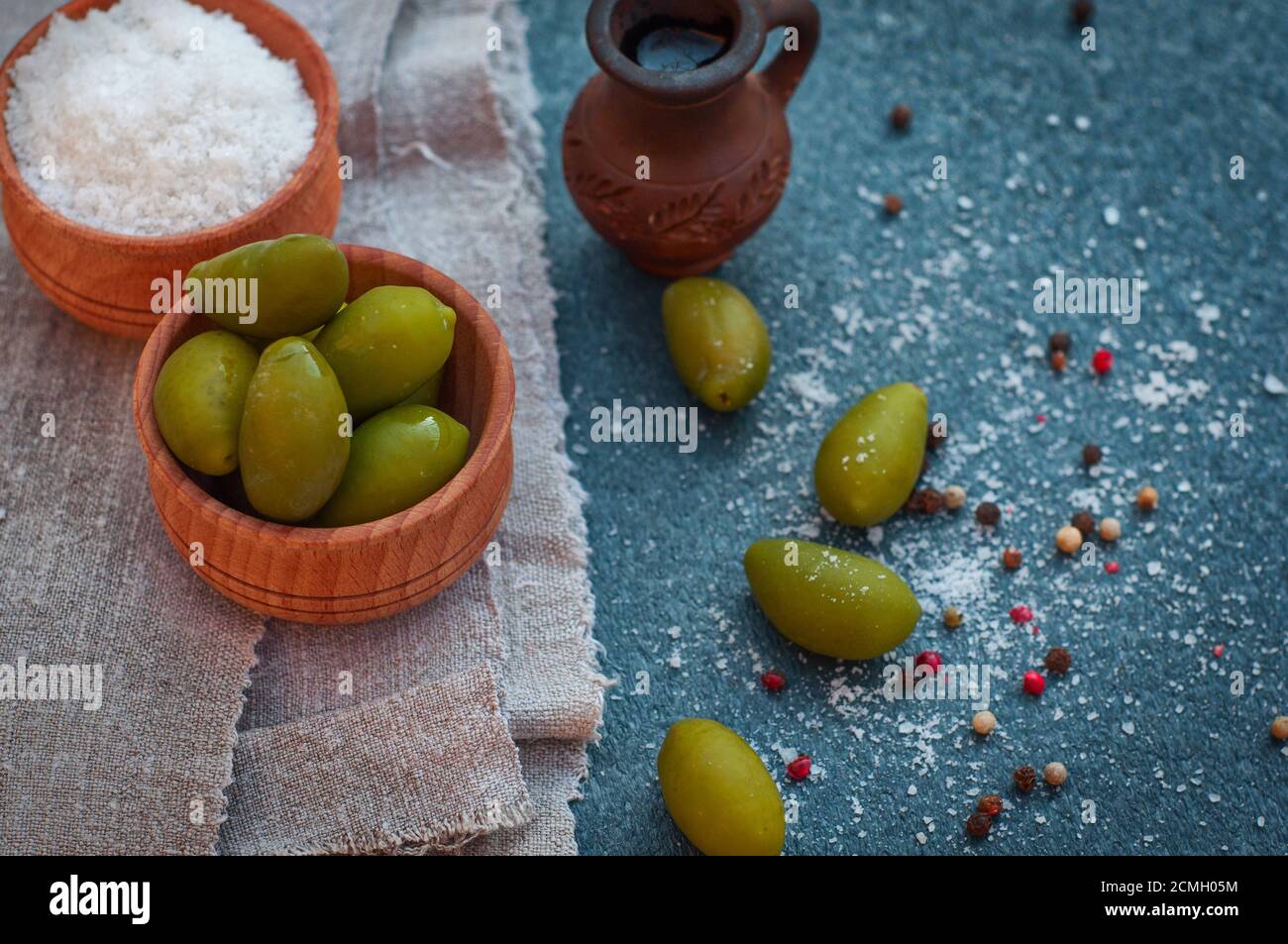 Green olives and olive oil in a clay pitcher Stock Photo - Alamy