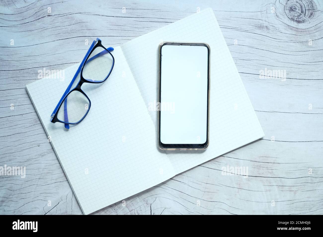 flat composition of smart phone and notepad on table Stock Photo - Alamy