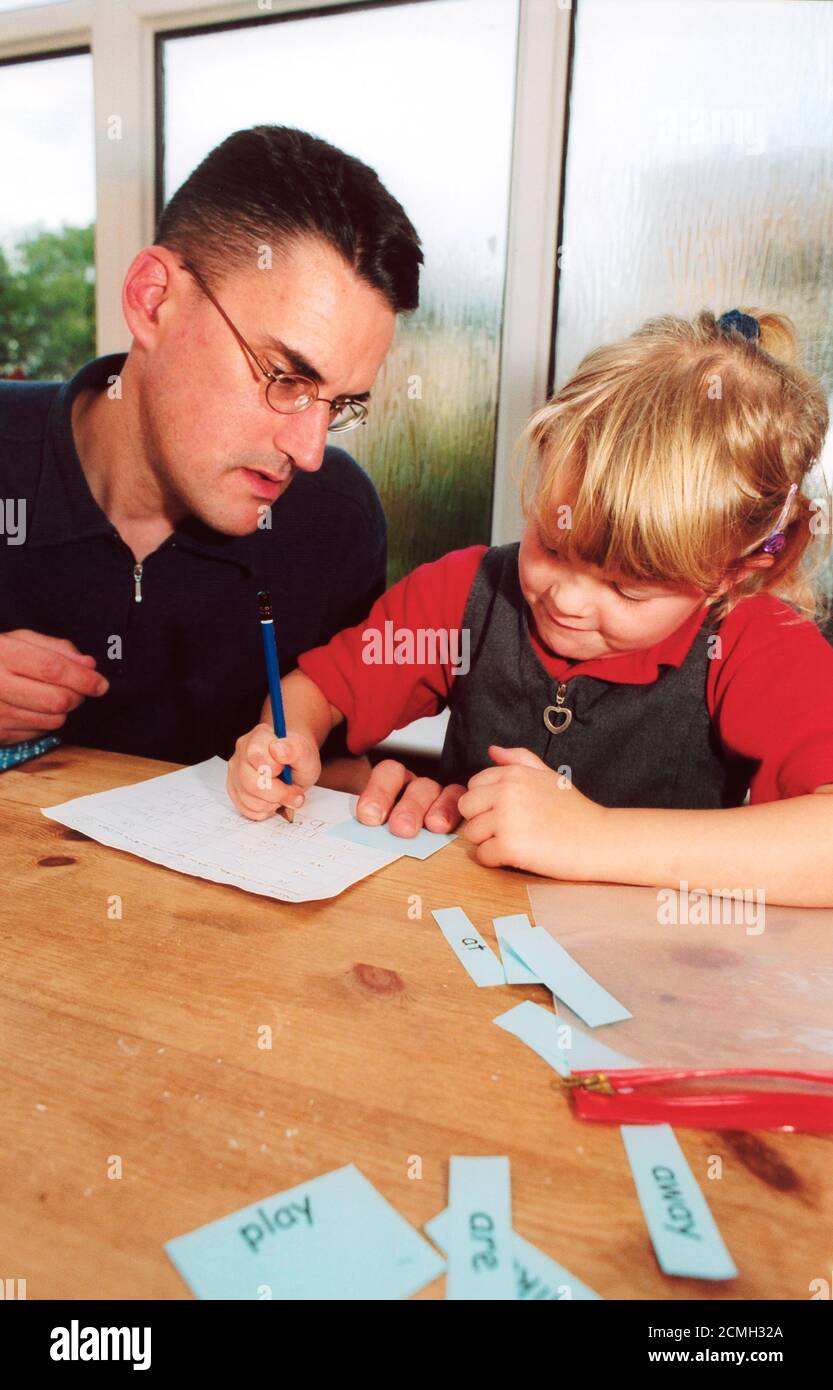 Father helping daughter with literacy skills Stock Photo - Alamy