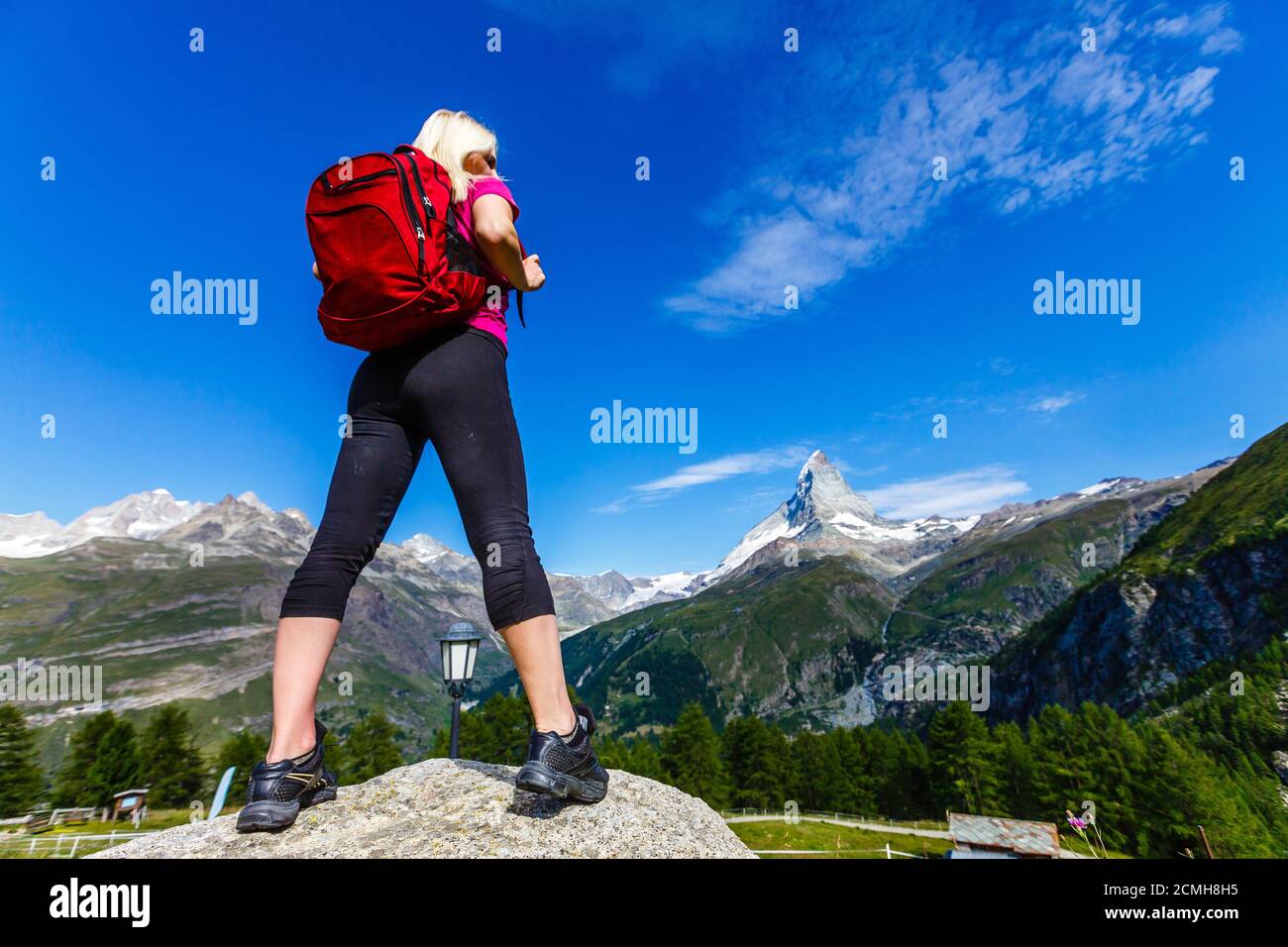 Woman hikers in the Alps, Matterhorn peak in Switzerland Stock Photo ...