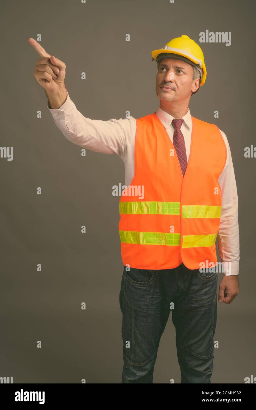 Portrait of man construction worker against gray background Stock Photo ...
