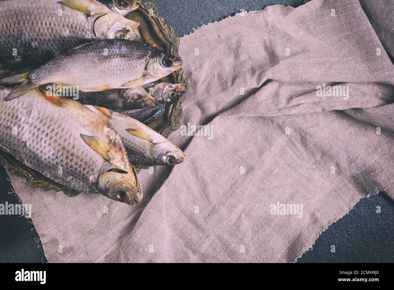 Dried fish on a copper plate, top view Stock Photo - Alamy