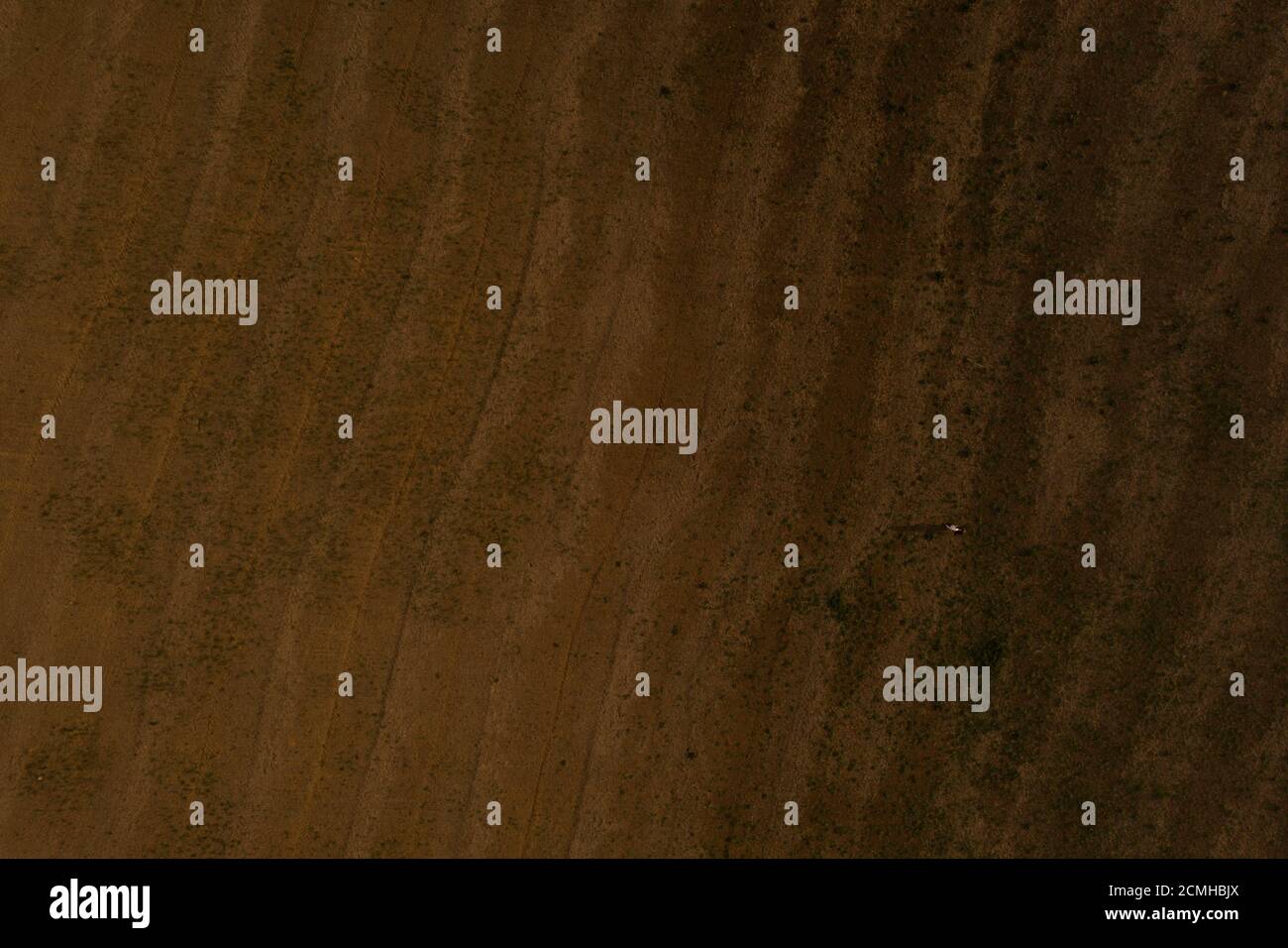 Aerial view from above. wavy field. brown earth Stock Photo - Alamy