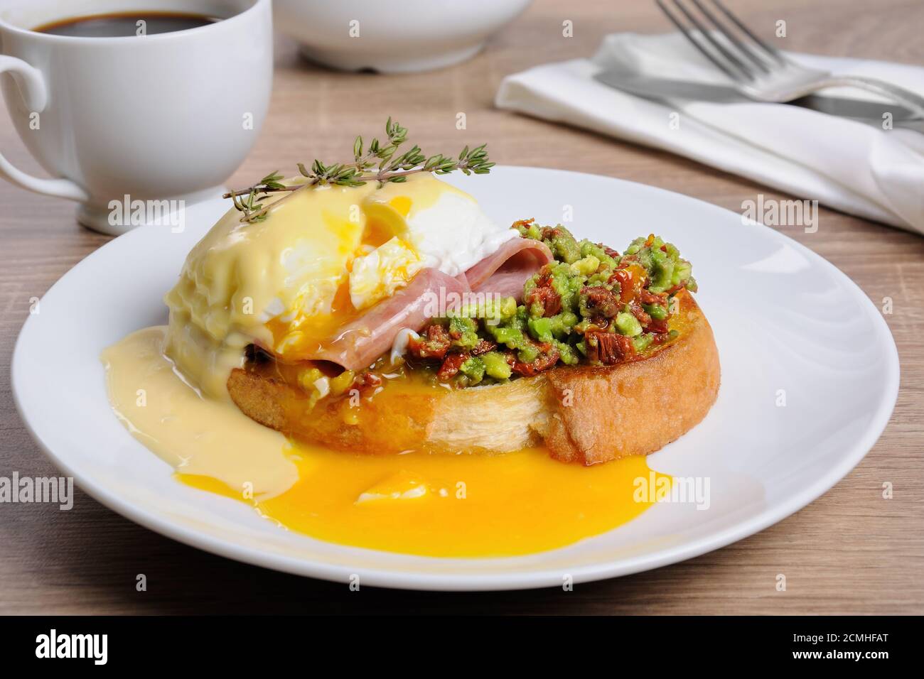 Toast with guacamole with egg Benedict Stock Photo - Alamy