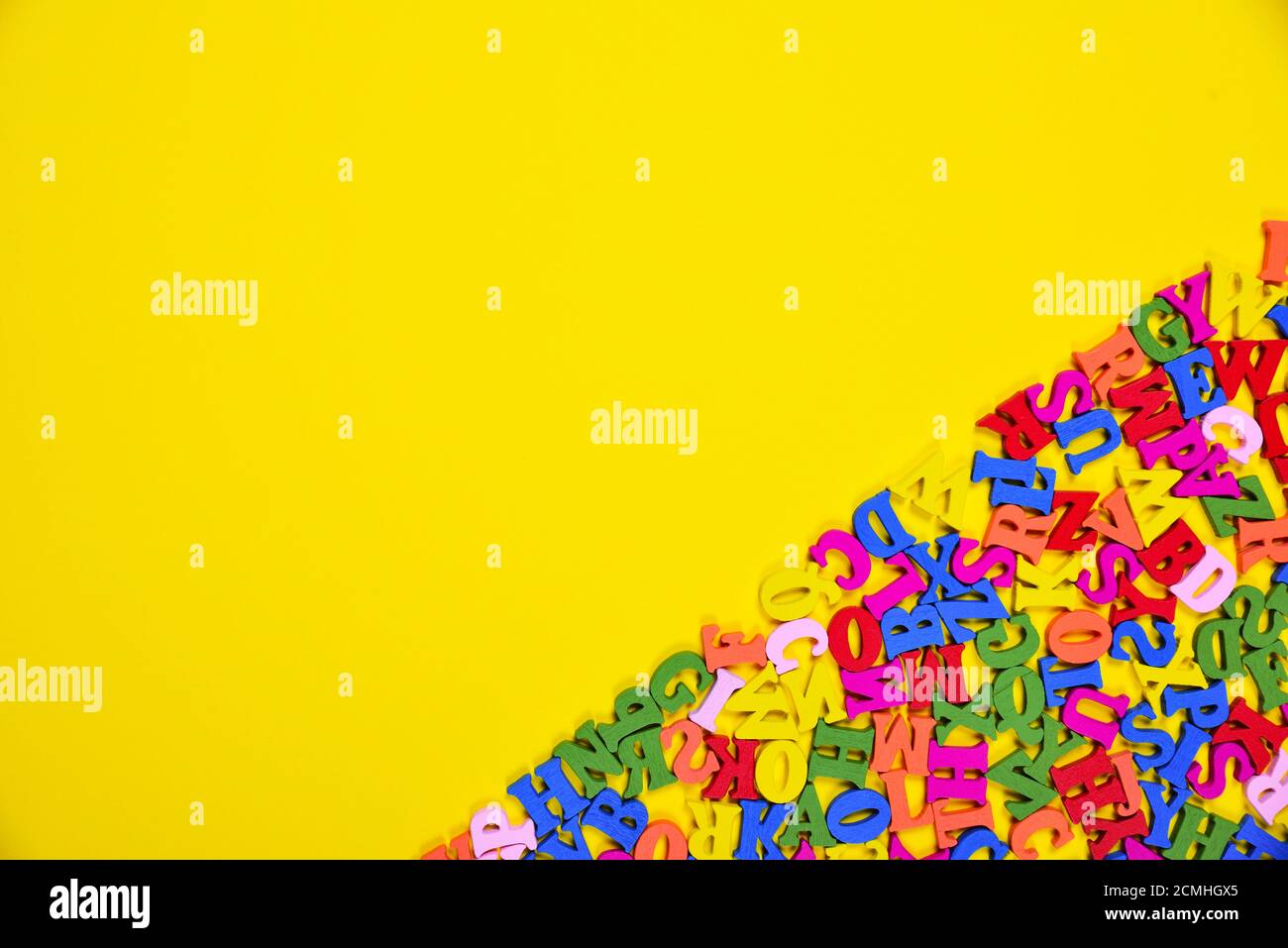 Abstract yellow background with multicolored letters Stock Photo - Alamy