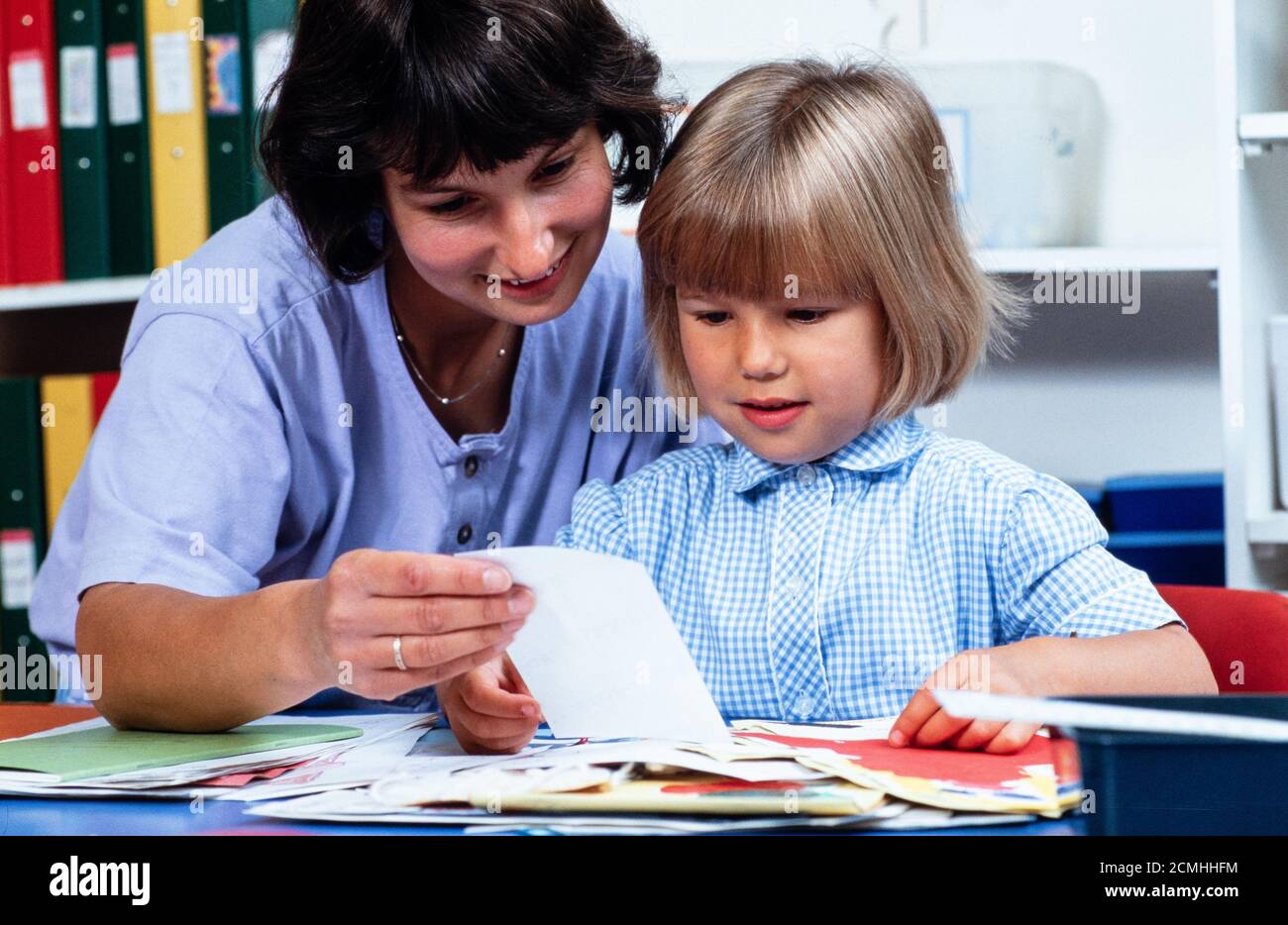 Parent and child woking together on assessment tasks as part of a new ...