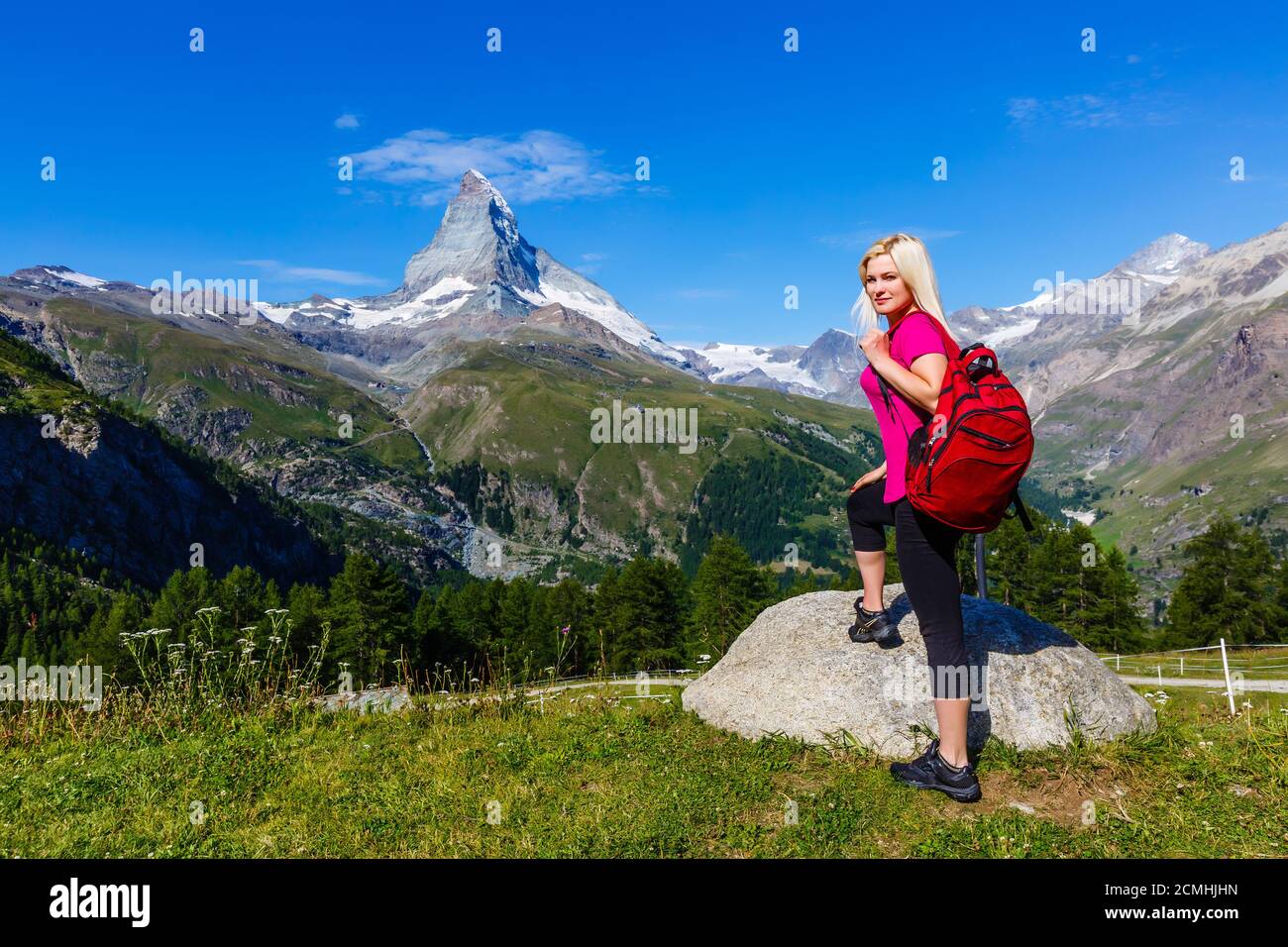 Woman hikers in the Alps, Matterhorn peak in Switzerland Stock Photo ...