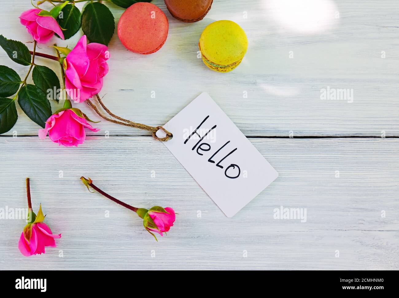 pink roses with inscription label and hello Stock Photo - Alamy
