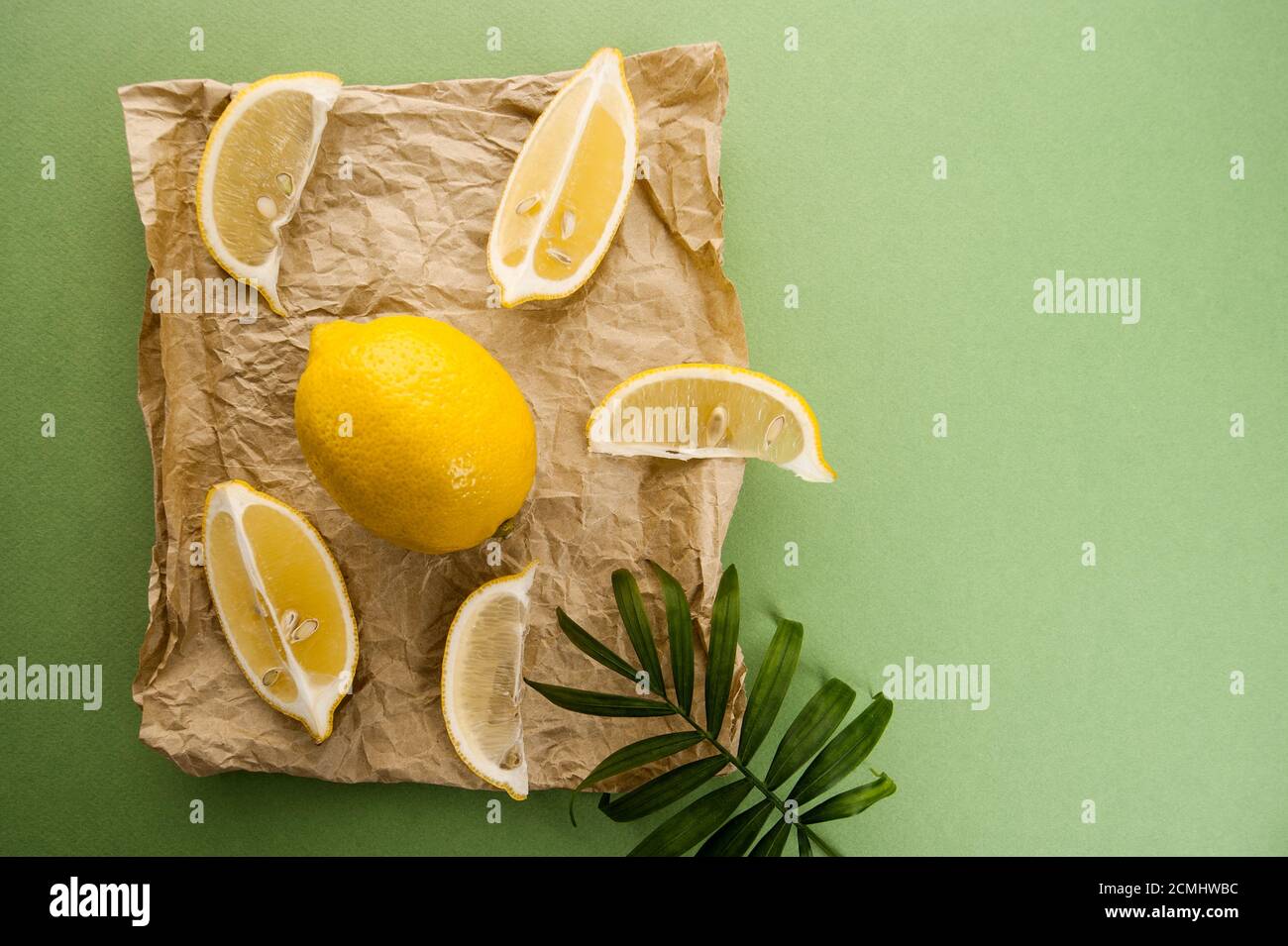 Lemons on kraft paper on a light green textured background Stock Photo ...