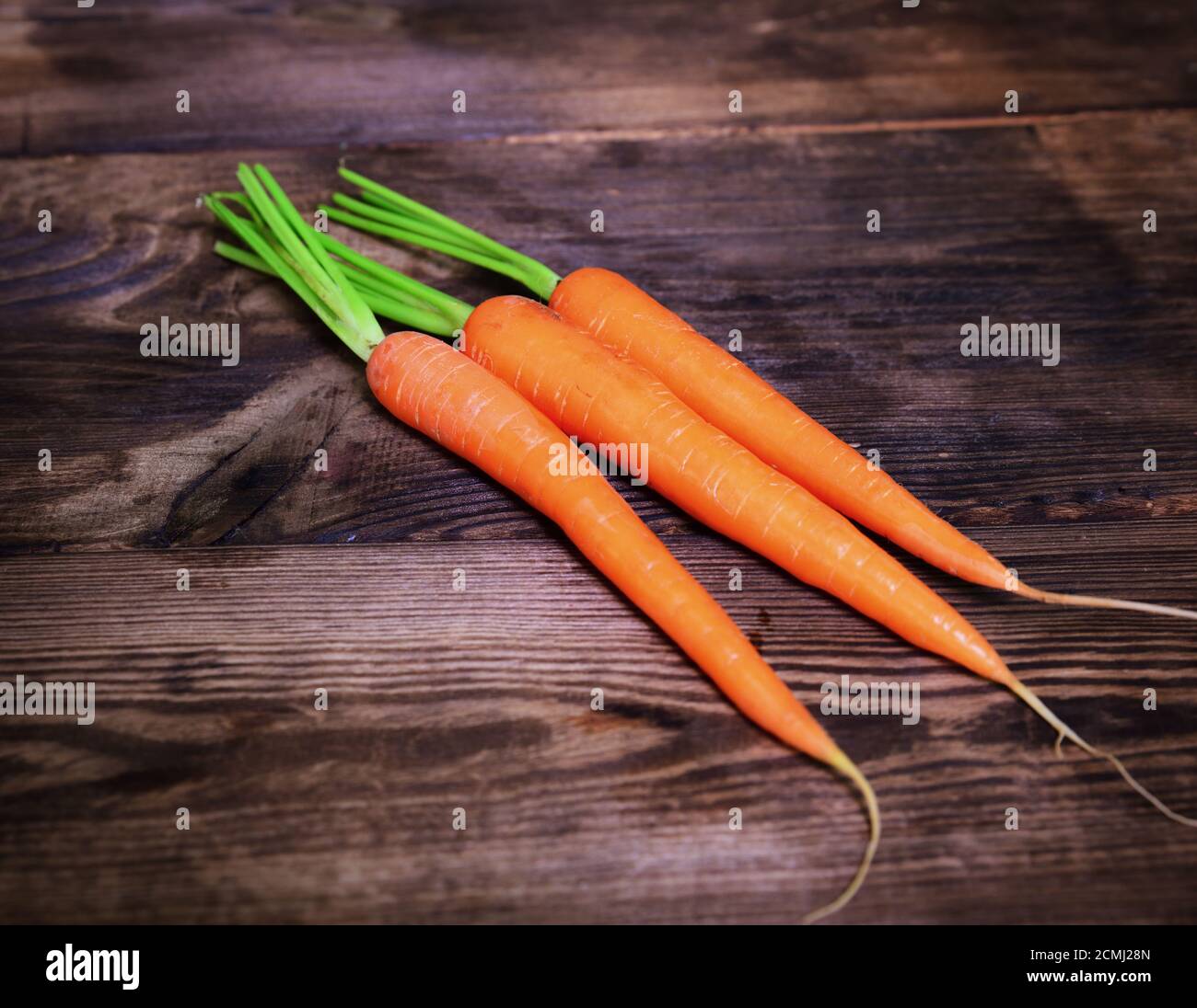 Three fresh carrots Stock Photo - Alamy