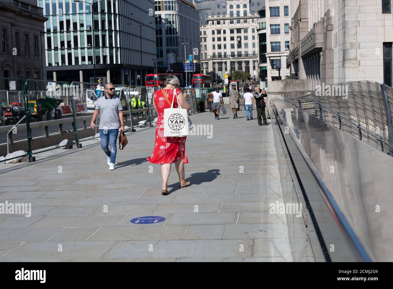 People walking across Historic London Bridge in London Stock Photo - Alamy