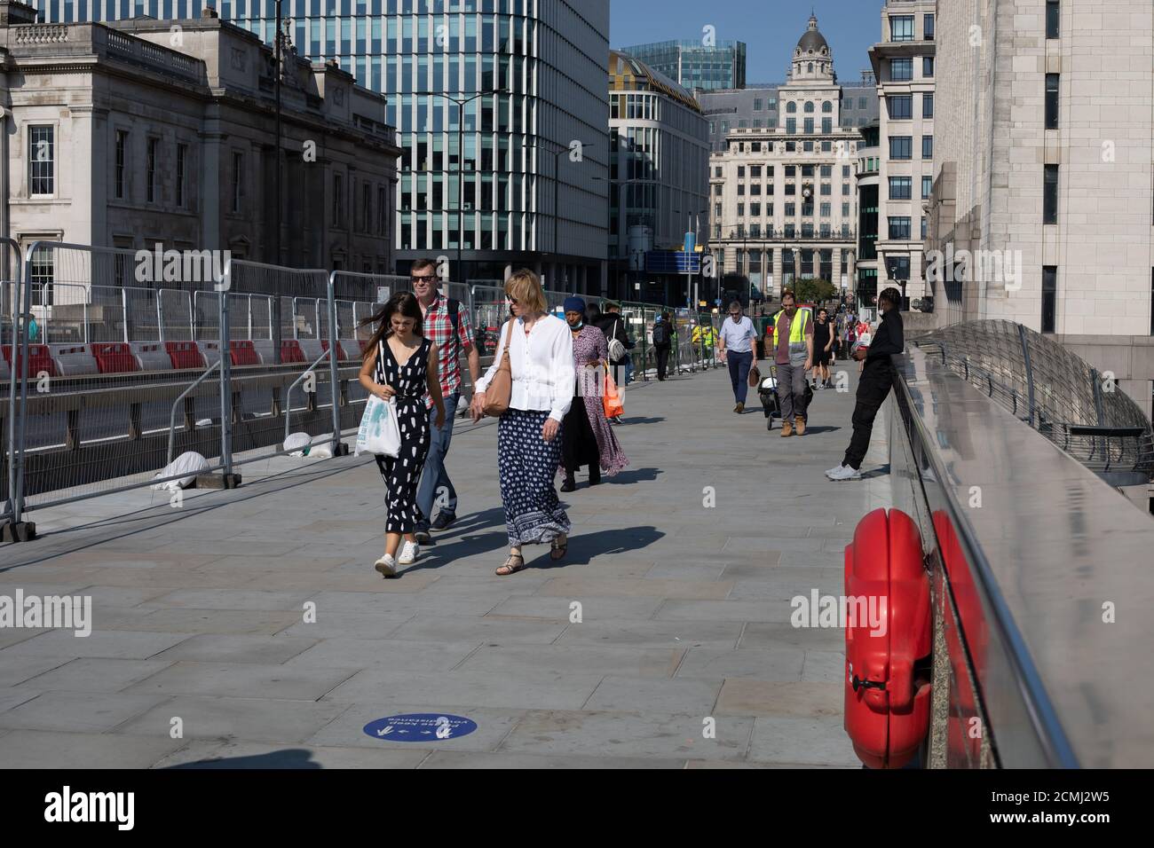 People walking across Historic London Bridge in London Stock Photo - Alamy