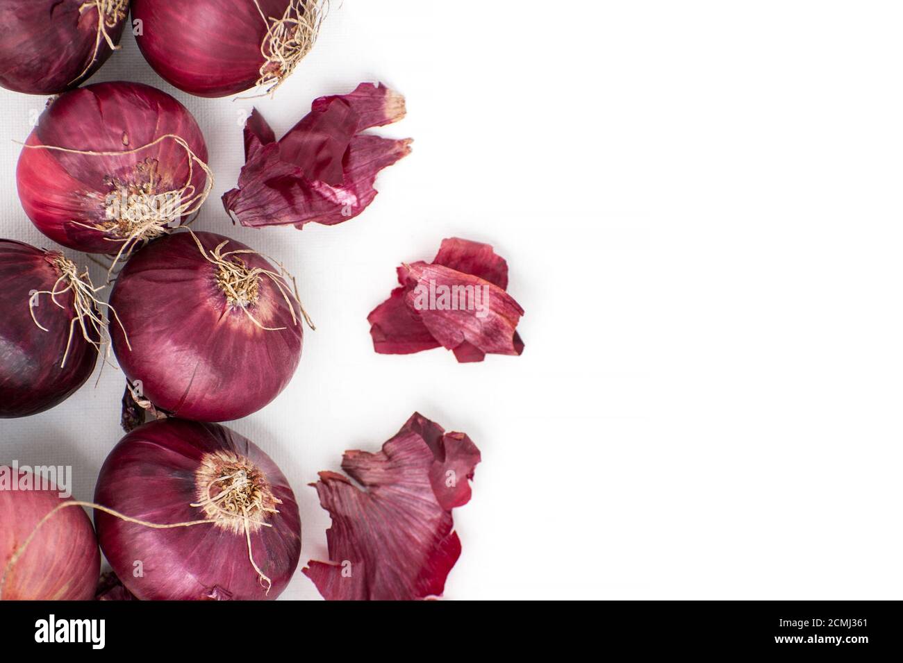 Red onion and peel close-up on a white background Stock Photo - Alamy