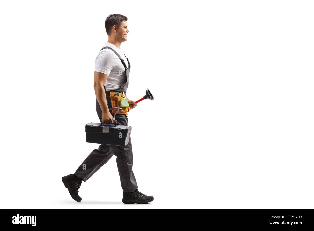 Full length profile shot of a repairman in a uniform walking and ...