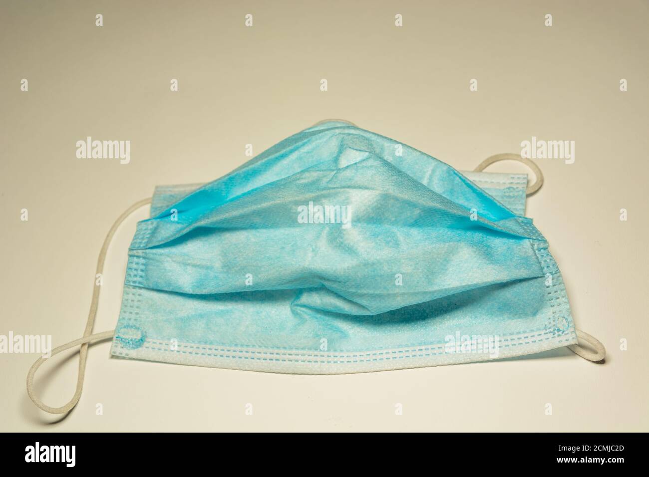 Worn out surgical mask blue colour, top view Stock Photo - Alamy