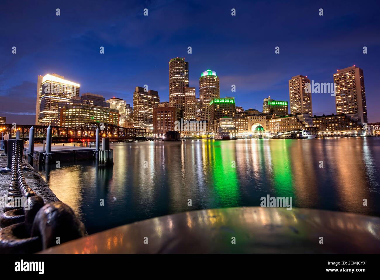 City of Boston with buildings and port at night, water reflections and ...