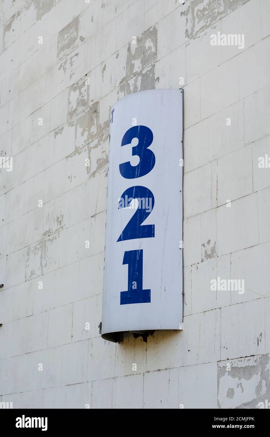 Semicircular sign on the wall with numbers 3,2,1. Vertical signboard on ...