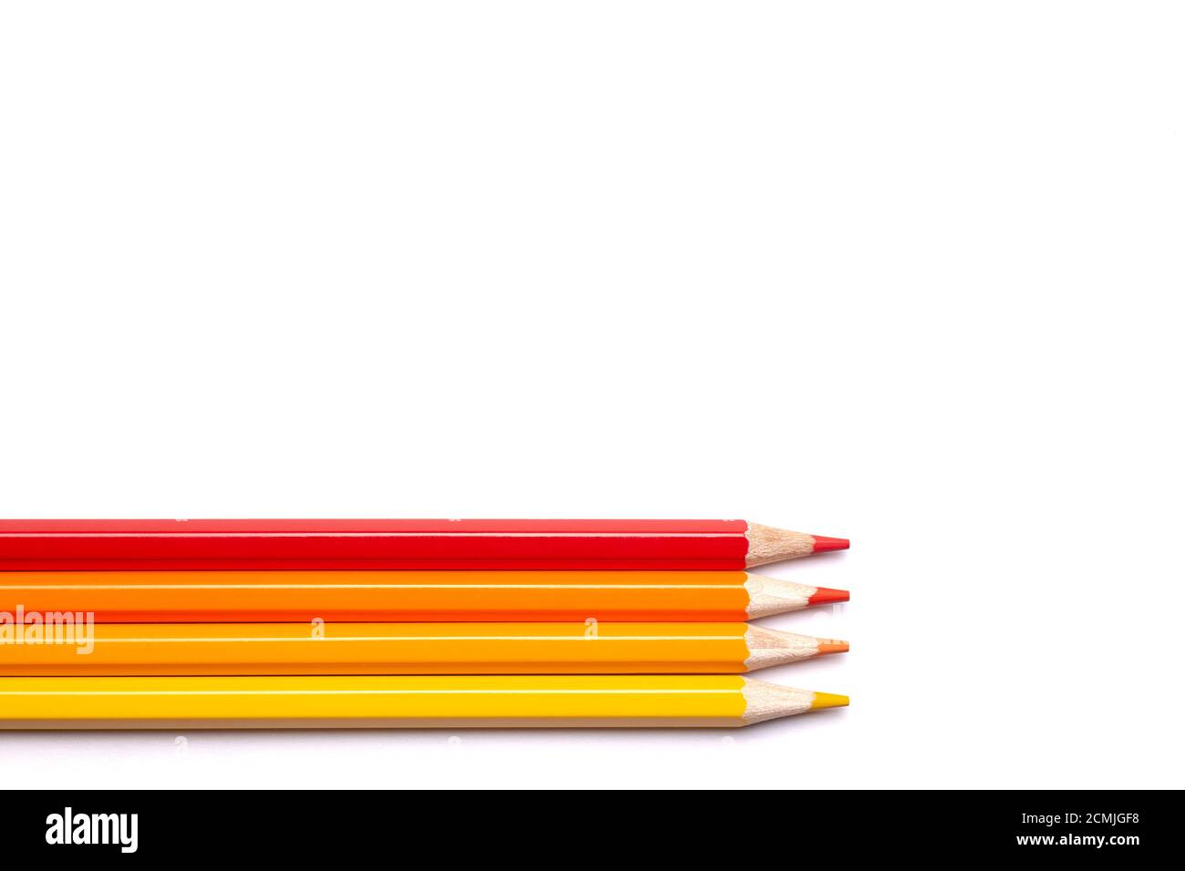 multi-colored wooden pencils in red shades on a white isolated ...