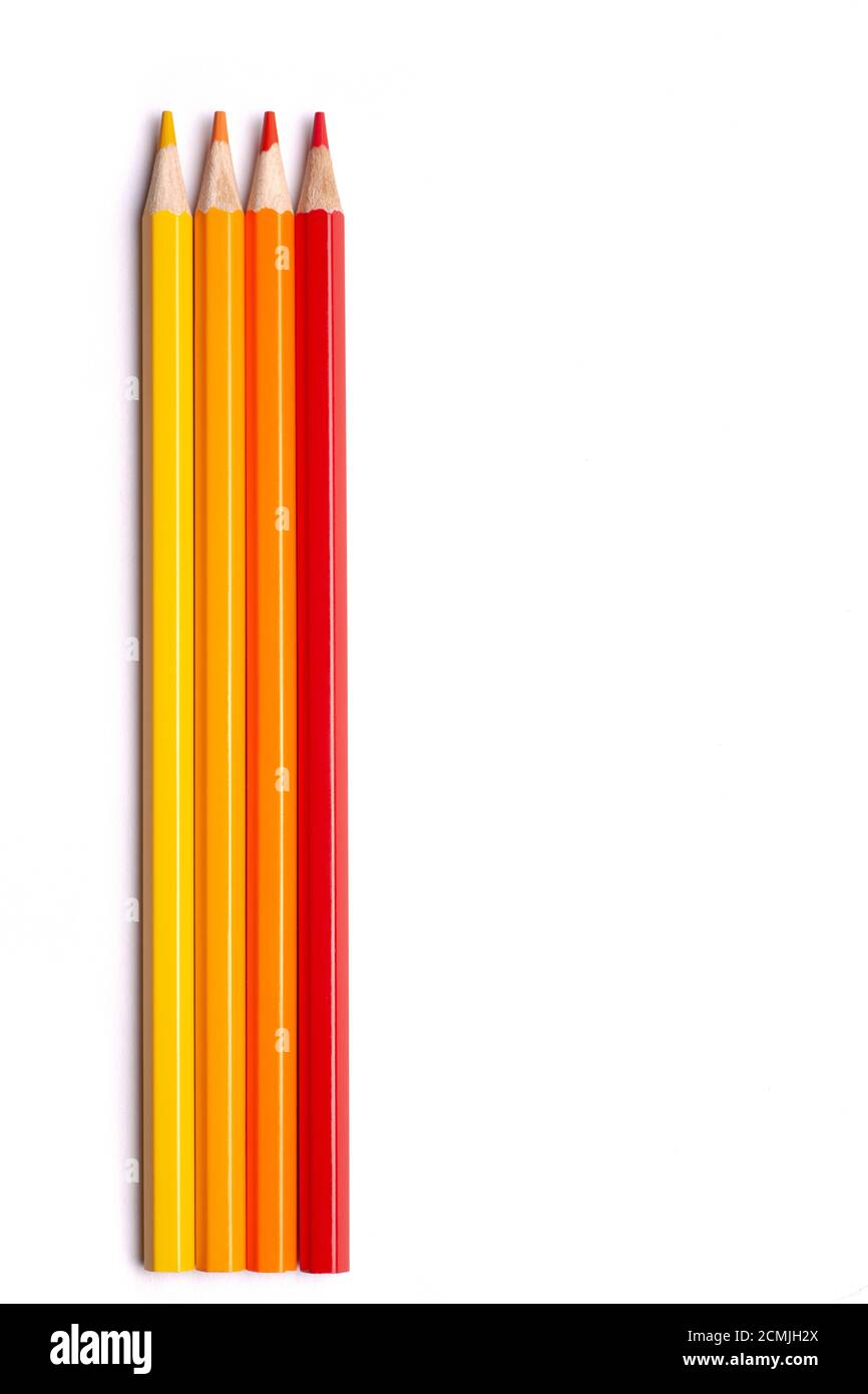 multi-colored wooden pencils in red shades on a white isolated ...