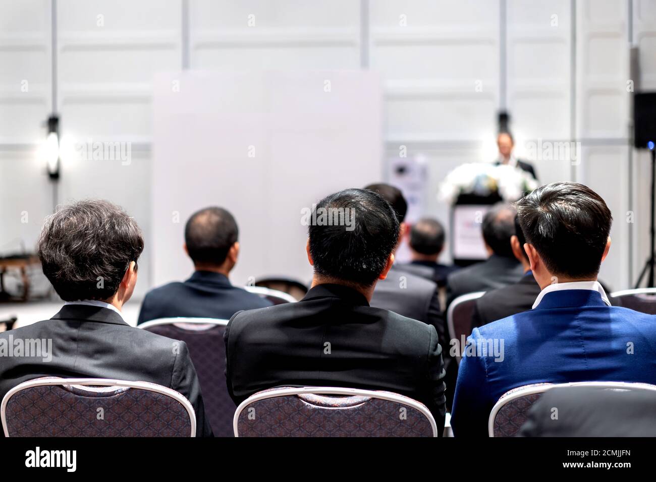 Backside of three Asian business men sit and listended speaker on the ...