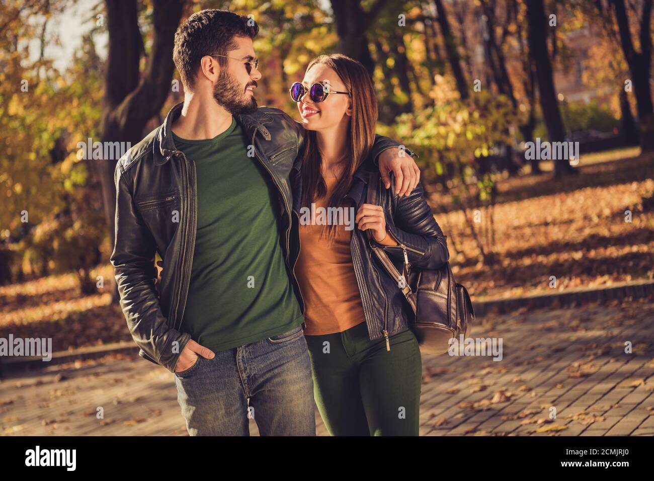 Photo of positive couple guy hug look at his girlfriend in fall october ...