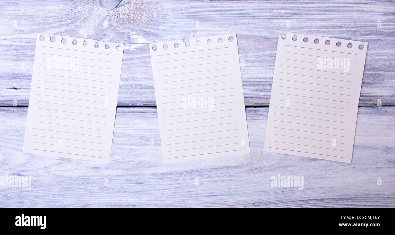 Three blank paper sheets in a line Stock Photo - Alamy