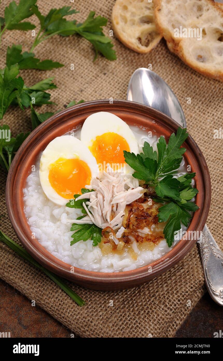 Rice porridge ginger congee with egg, chicken, crispy shallots and ...
