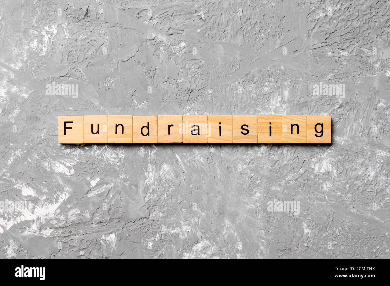 fundraising word written on wood block. fundraising text on table ...
