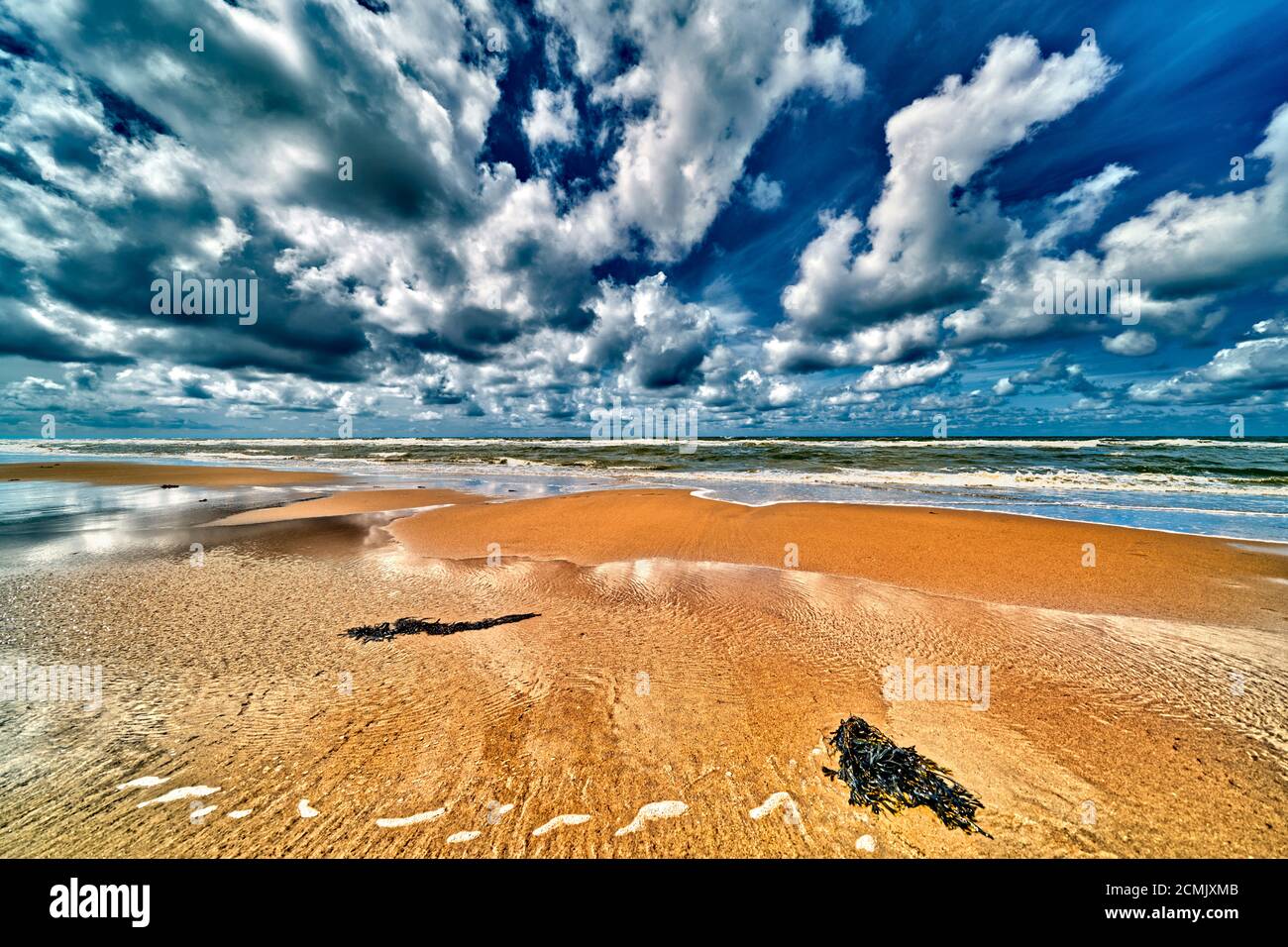 the north sea beach with clouds and sun , wide angle view of the ...