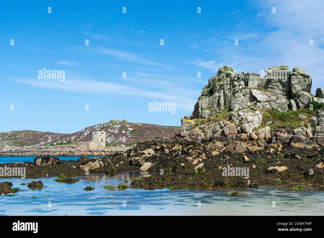 Hangman Island off the coast of Bryher, and behind it Cromwell's Castle ...