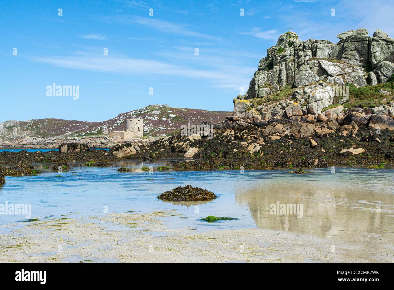 Hangman Island off the coast of Bryher, and behind it Cromwell's Castle ...