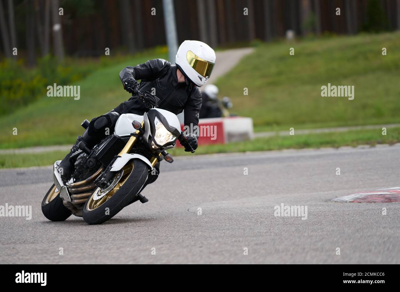 Handsome motorcyclist in black riding his super sport motorcycle Stock ...