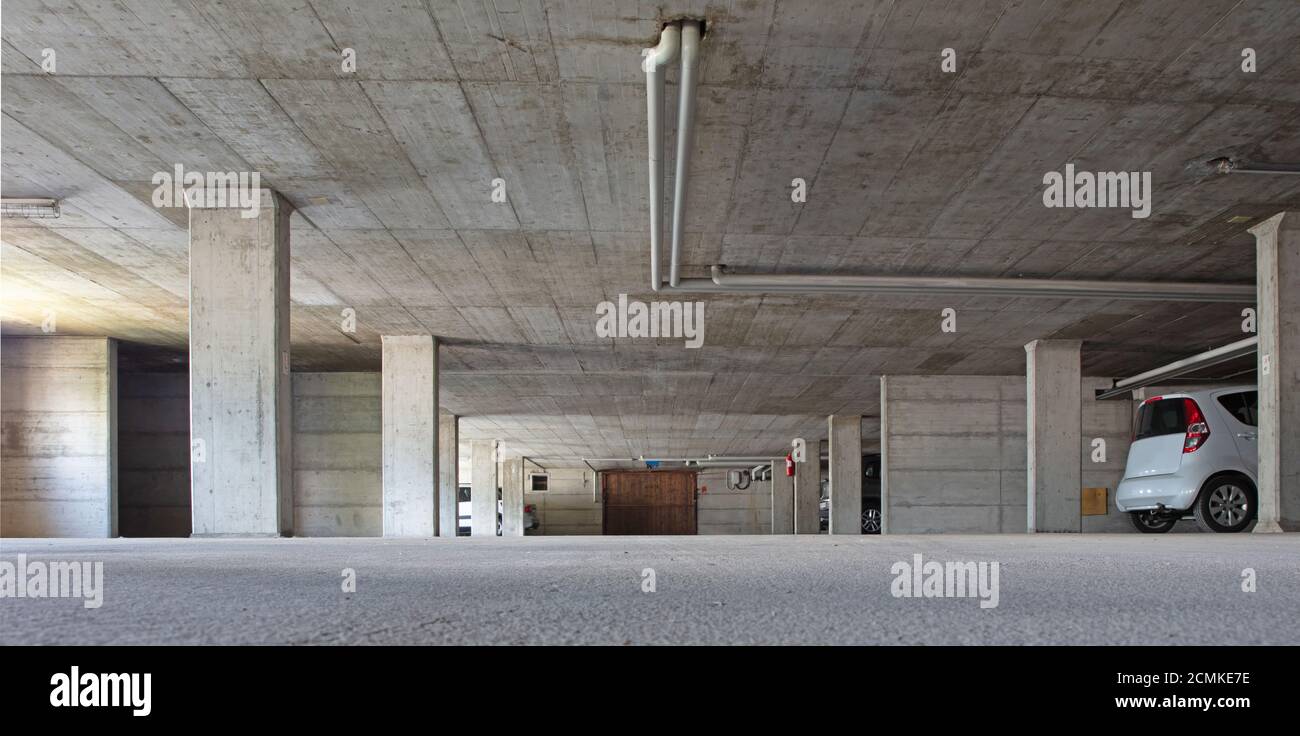 Parking garage underground, unwelcoming concrete walls, selective focus ...